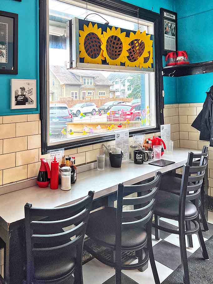 Turquoise walls and sunflower decorations create a cheerful backdrop for serious breakfast business.