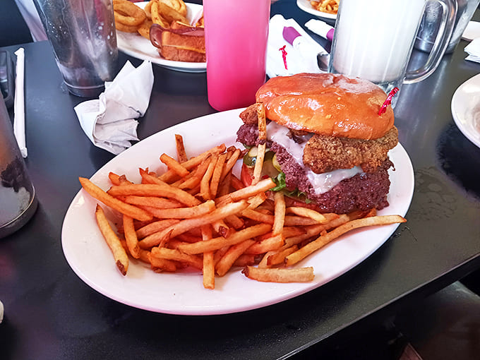 A towering burger creation demands your full attention &ndash; the kind of meal that requires strategic planning before the first magnificent bite.