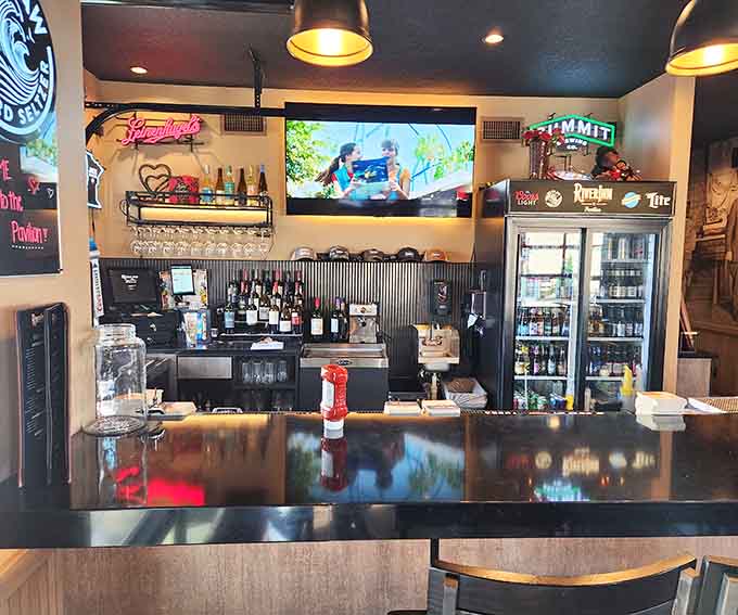 The well-stocked bar stands ready to craft your beverage of choice, whether that's a cold beer or something more creative.