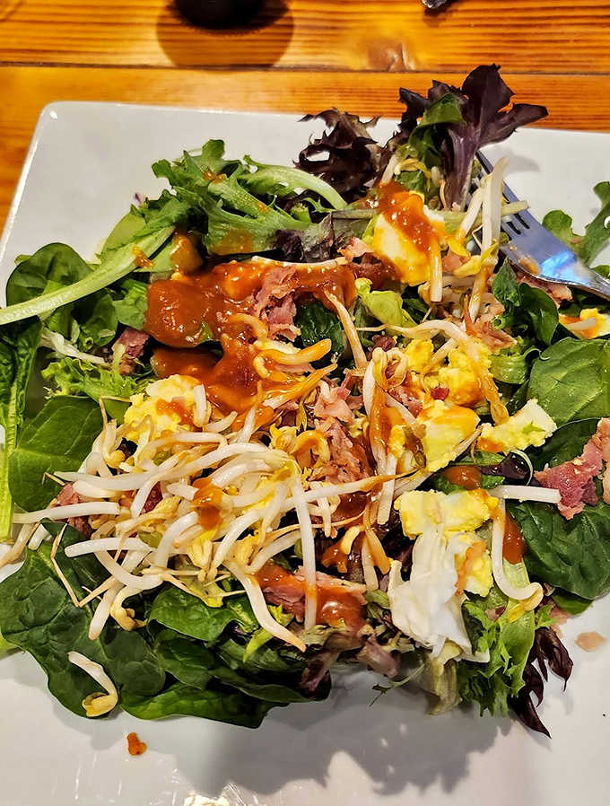 Fresh greens, colorful vegetables, and protein come together in a vibrant salad that proves lighter fare gets the same attention as heartier dishes.