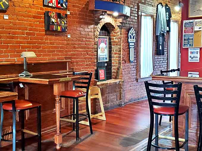 Comfortable seating options accommodate every mood, from high-tops for casual gatherings to intimate tables tucked into brick-framed nooks for quieter conversations.