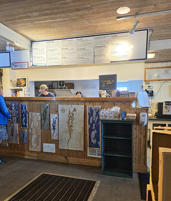 The service counter where sandwich magic happens, with friendly staff ready to craft your perfect Vermont meal experience.
