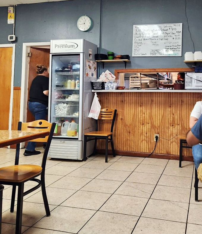 The service counter where magic happens &ndash; watch as orders fly in and perfectly plated comfort food emerges with remarkable efficiency.