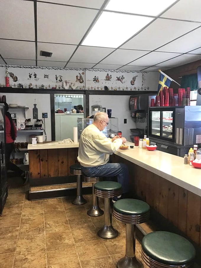The classic counter with spinning stools offers front-row seats to the culinary theater where coffee cups never reach empty.