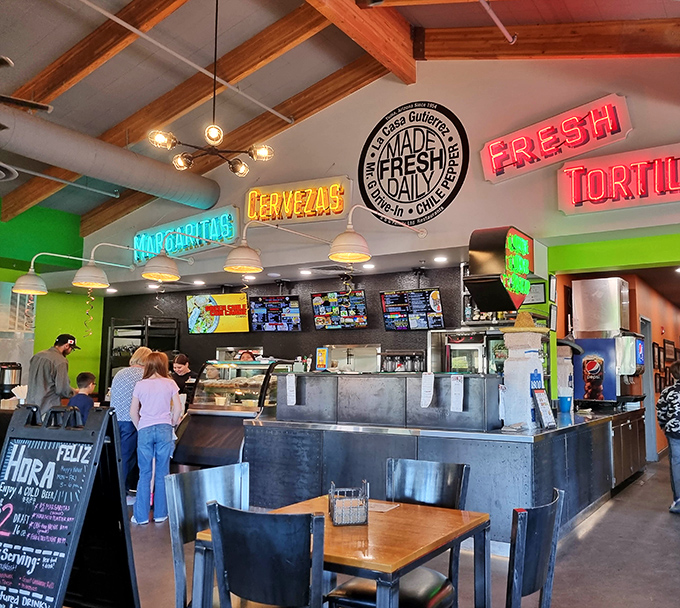 Neon signs promising "MARGARITAS" and "CERVEZAS" illuminate the service counter where culinary magic begins &ndash; promises that will definitely be kept.