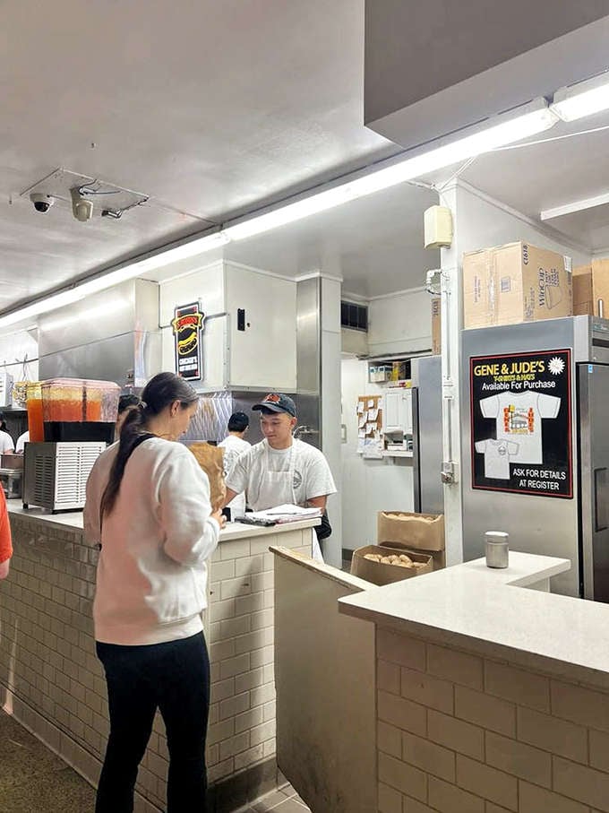 Behind this counter, hot dog magic happens with clockwork precision &ndash; no wasted motions, just decades of perfected craft on display.