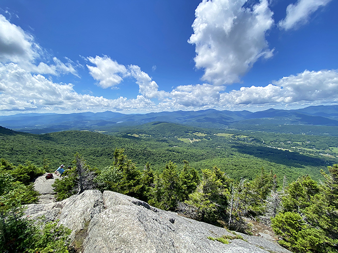 The view from Mount Mansfield stretches for miles, rewarding hikers with panoramic vistas across Vermont's undulating green landscape.