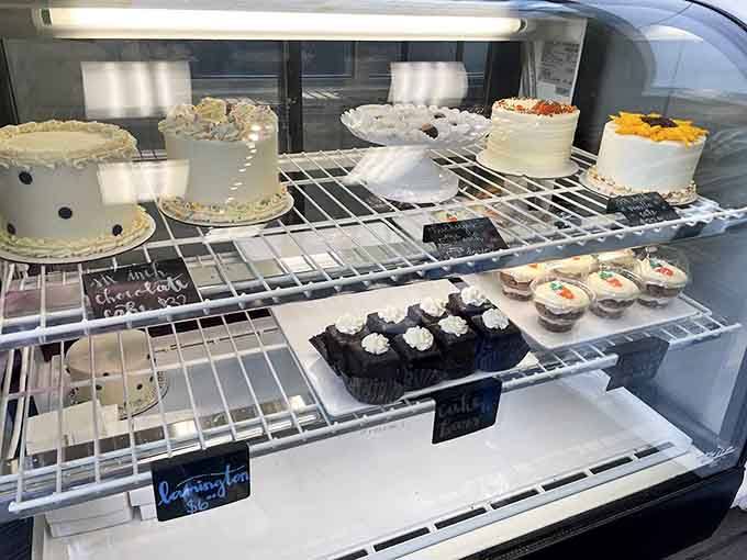 Layer cakes stand ready for celebrations, each one frosted and decorated with the care usually reserved for wedding cakes.