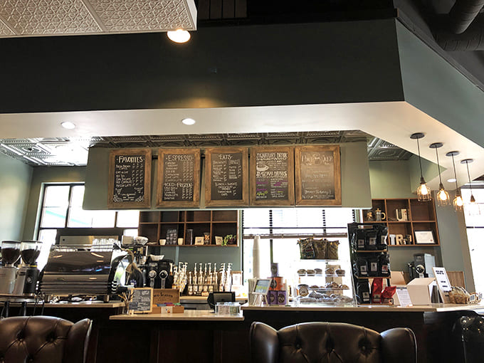 The service counter showcases their serious espresso machine and pastry case, where dreams are made and calories are temporarily forgotten.