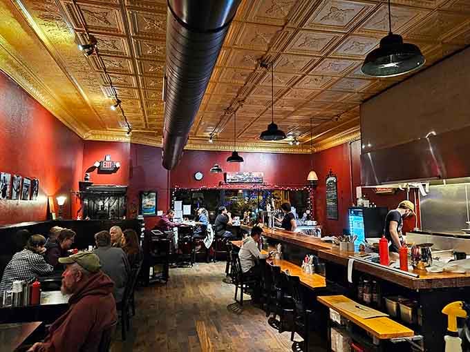 Exposed ductwork and pendant lights creating that casual-cool vibe where everyone feels welcome, fancy or not.