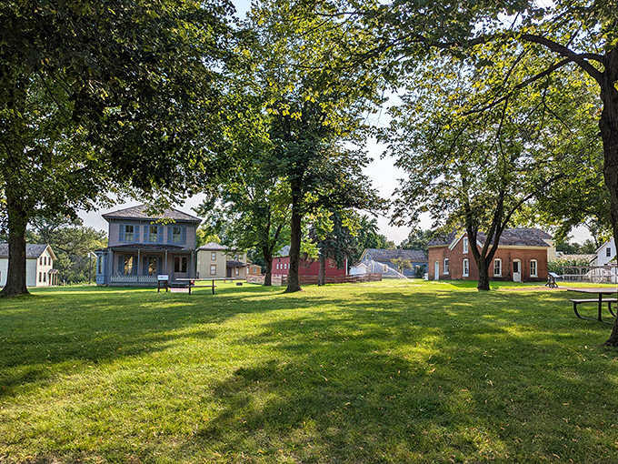 Towering trees provide shade for the historic buildings, silent witnesses that have watched generations come and go beneath their branches.