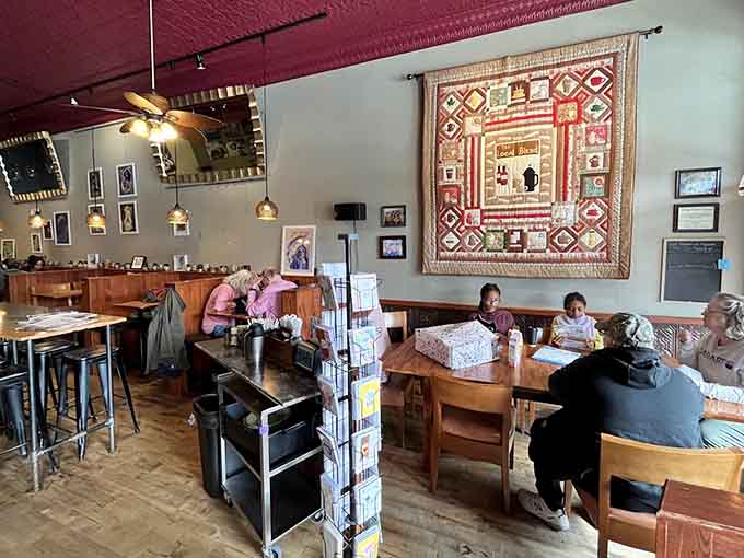 Cozy seating areas with local artwork create intimate spaces perfect for conversation, contemplation, or catching up on reading.