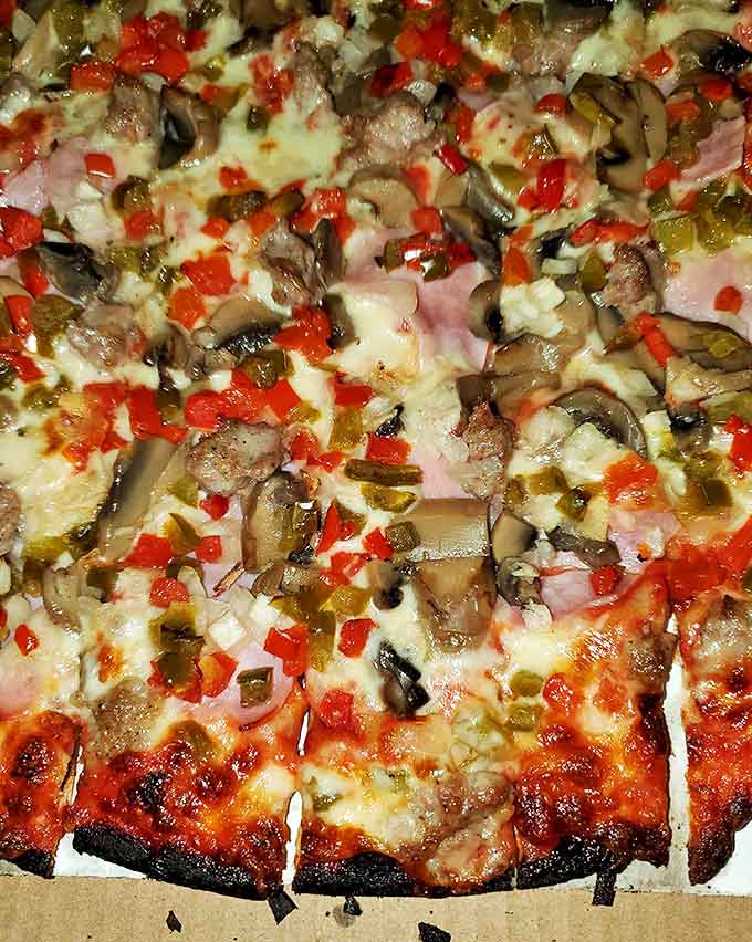 A perfect canvas of crispy-yet-chewy dough supporting a masterpiece of toppings – the Goldilocks of pizza crusts.