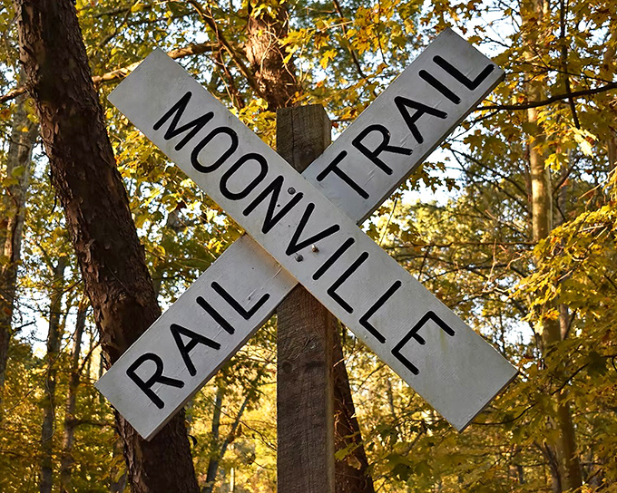 The iconic Moonville Rail Trail sign stands sentinel among autumn foliage, guiding adventurers through this historic corridor.