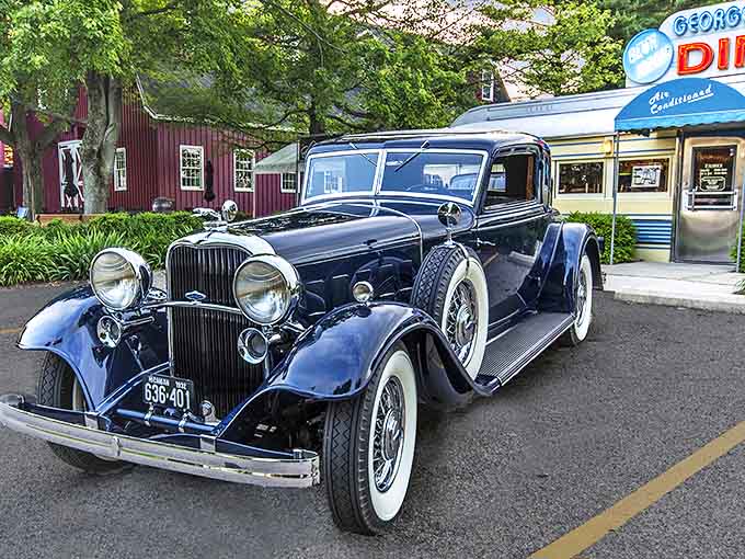 A gleaming classic automobile parked outside the diner creates a perfect time-travel tableau. Some scenes just feel right, like they've always existed.