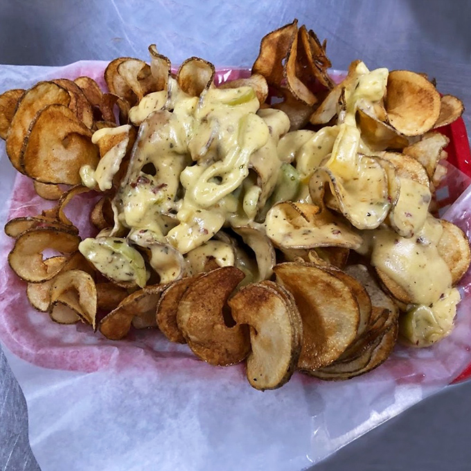 Homemade potato chips with cheese sauce &ndash; a dangerously addictive appetizer that disappears faster than you can say "just one more."