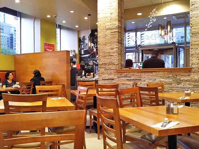 The dining room balances intimacy with energy, where wooden tables and stone accents create a space that feels both special and comfortable.