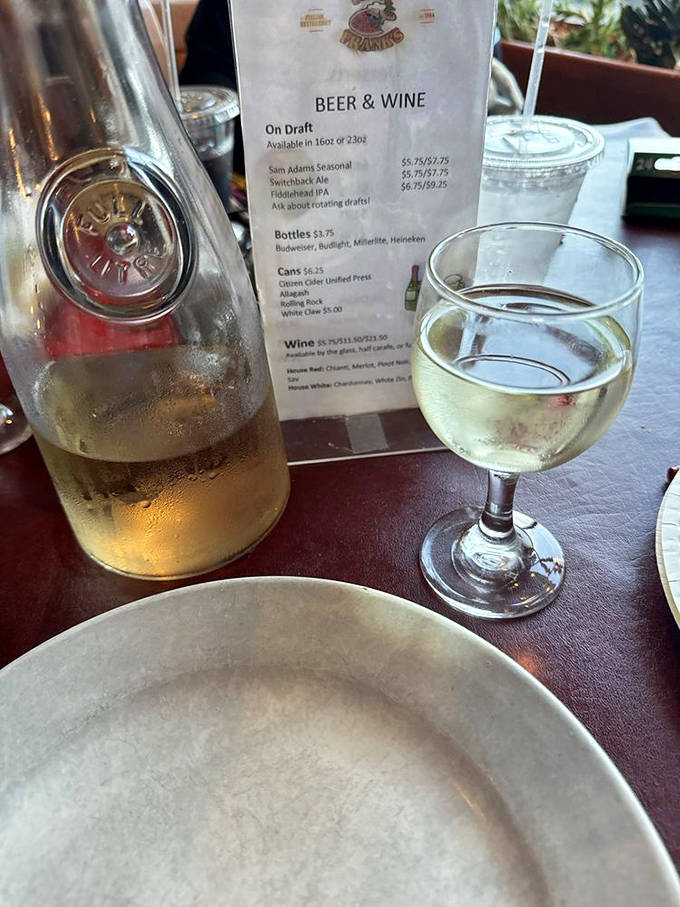 House wine served without pretension. That carafe has probably witnessed more heartfelt conversations than most therapists' offices.