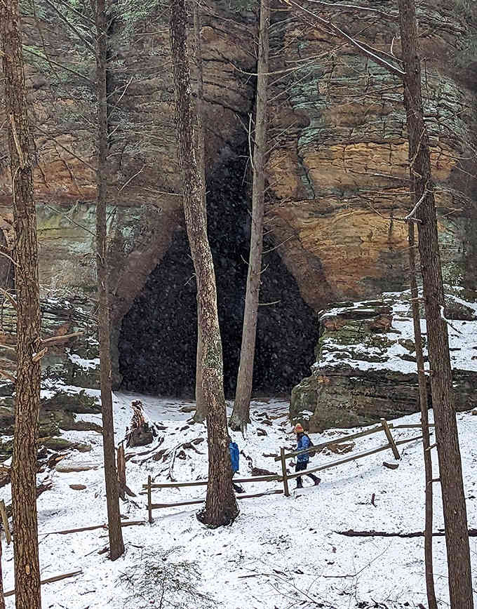 Winter transforms Chapel Cave into a frosted wonderland, where snow-dusted paths lead to the dark mystery of the cave's entrance.