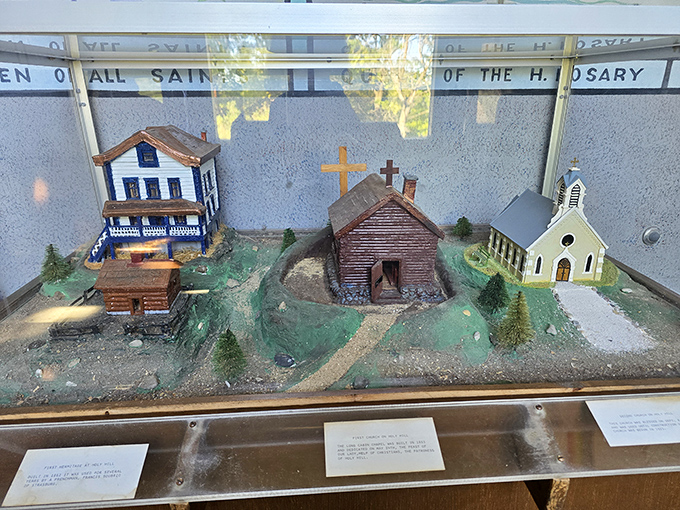A charming diorama depicts the early settlement that would eventually grow around the sacred hill, preserving history in miniature.