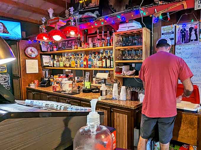 The bar area glows with neon promise, offering liquid refreshment to complement your solid food choices perfectly.