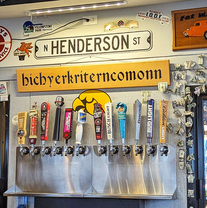 Beer taps stand at attention beneath the Henderson Street sign, ready to pour liquid refreshment for thirsty travelers and locals alike.
