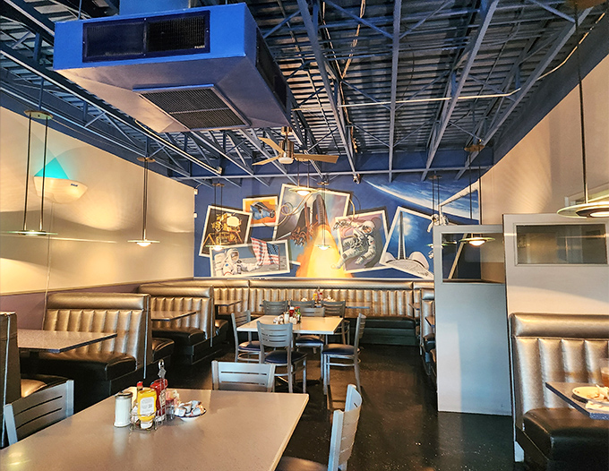 Comfortable booth seating against cosmic blue walls creates the perfect atmosphere for enjoying your meal while plotting your next desert adventure.