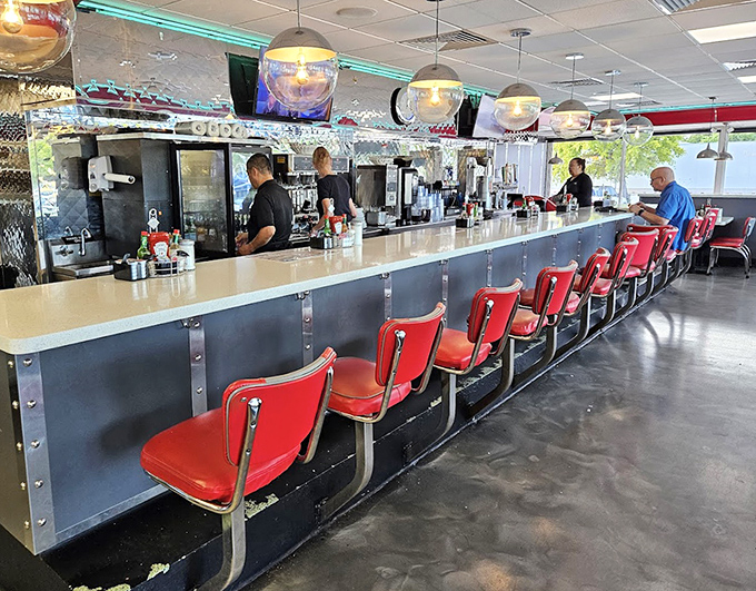 The diner counter at Lester's offers front-row seats to the culinary show, where efficiency meets hospitality under the glow of vintage lighting.