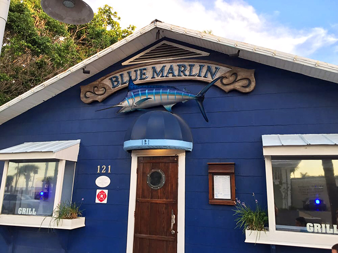 The cozy bar area invites patrons to settle in, with warm wood tones and nautical touches creating an atmosphere of relaxed sophistication.