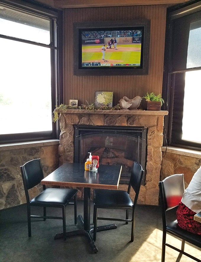 A cozy fireplace corner where sports on TV and comfort food create the perfect recipe for forgetting your worries.