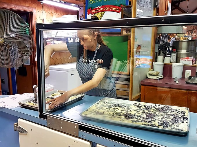 A baker prepares another batch of blueberry-studded delights, folding Maine's wild harvest into what will soon become someone's favorite vacation memory.