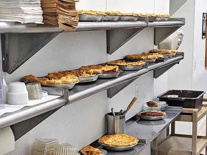 Behind the scenes, freshly baked pies cool on racks before making their grand entrance to the display case and ultimately to eager diners.