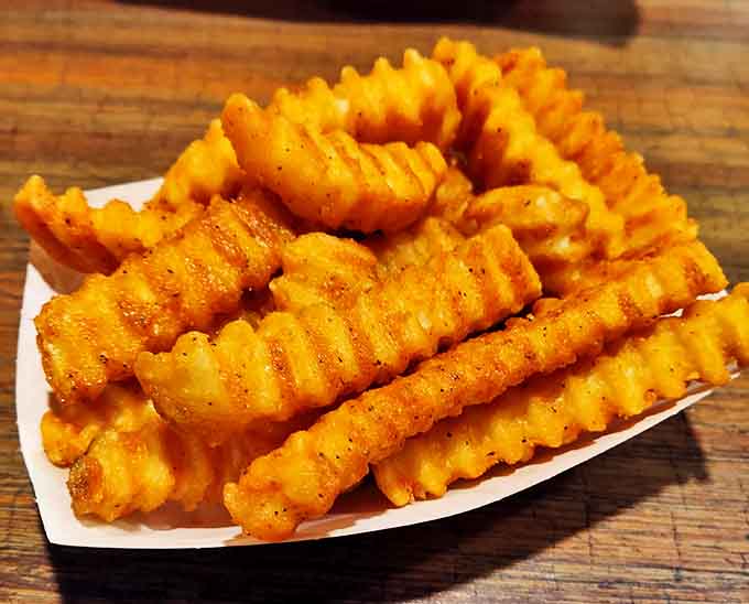 These aren't just any fries &ndash; Kewpee's golden crinkle-cuts achieve that perfect balance of crispy exterior and fluffy interior that keeps customers coming back for decades.