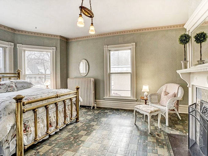 Brass bed frames and delicate wallpaper create a guest room that feels both luxurious and intimate – Victorian hospitality with a modern mattress.