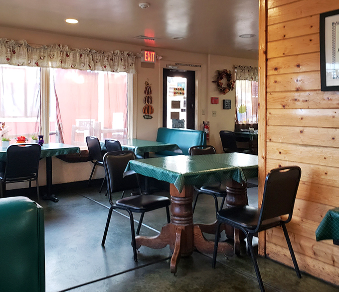 Sunlight streams through windows onto pine-paneled walls, illuminating a dining room where every detail feels thoughtfully chosen rather than designer-curated.