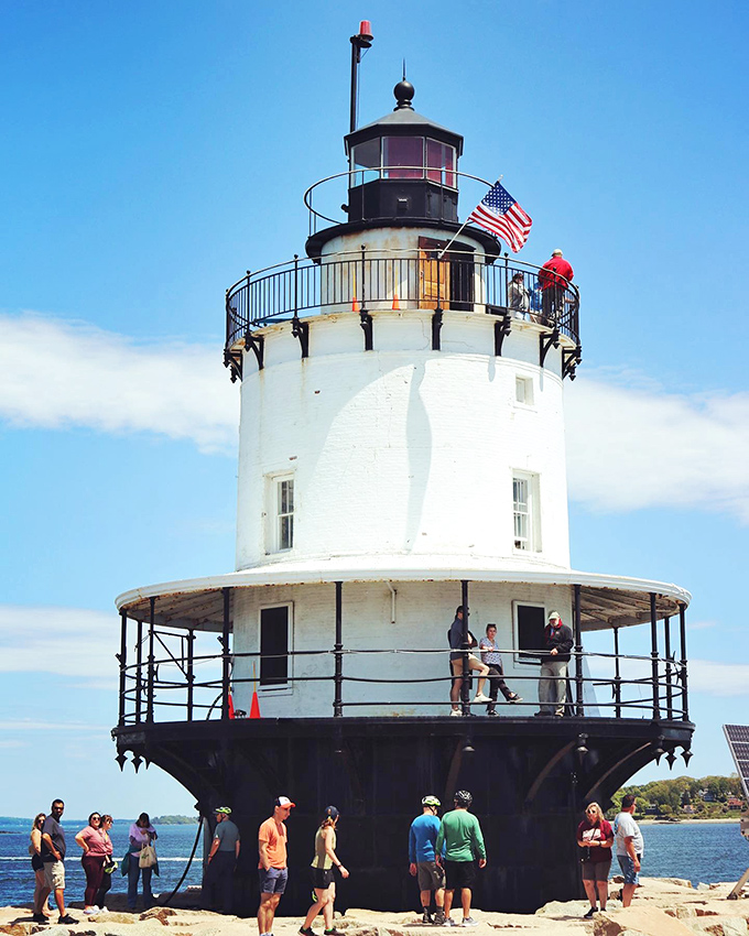 Visitors can explore the pristine white lighthouse up close, discovering the craftsmanship and history behind its impressive design.