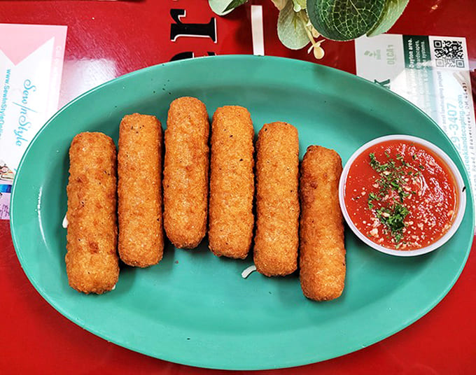 These aren't your average mozzarella sticks – crispy exterior giving way to perfectly molten cheese that stretches dramatically with each bite.