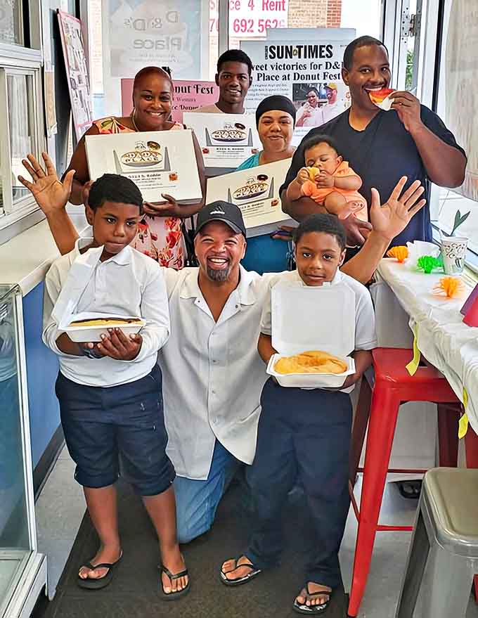 Happy customers gather with their prized donut boxes, showcasing the community spirit that makes D&D's Place more than just a bakery.