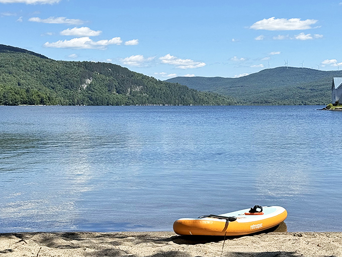 Mountain majesty: Crystal Lake's calm waters reflect Vermont's rolling hills under a perfect blue sky.