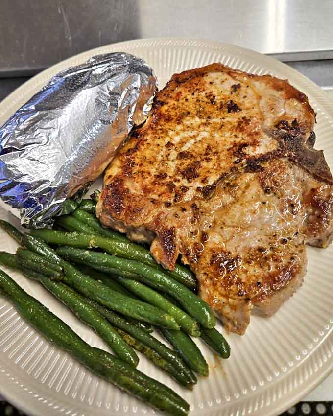 A properly cooked pork chop with green beans and potato proves that Thursday's special gives the famous ribs some serious competition.