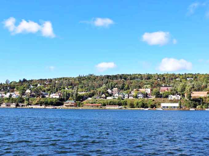 Riverside views showcase Houghton's perfect balance of natural beauty and developed community, with hills rising gently from the water's edge.