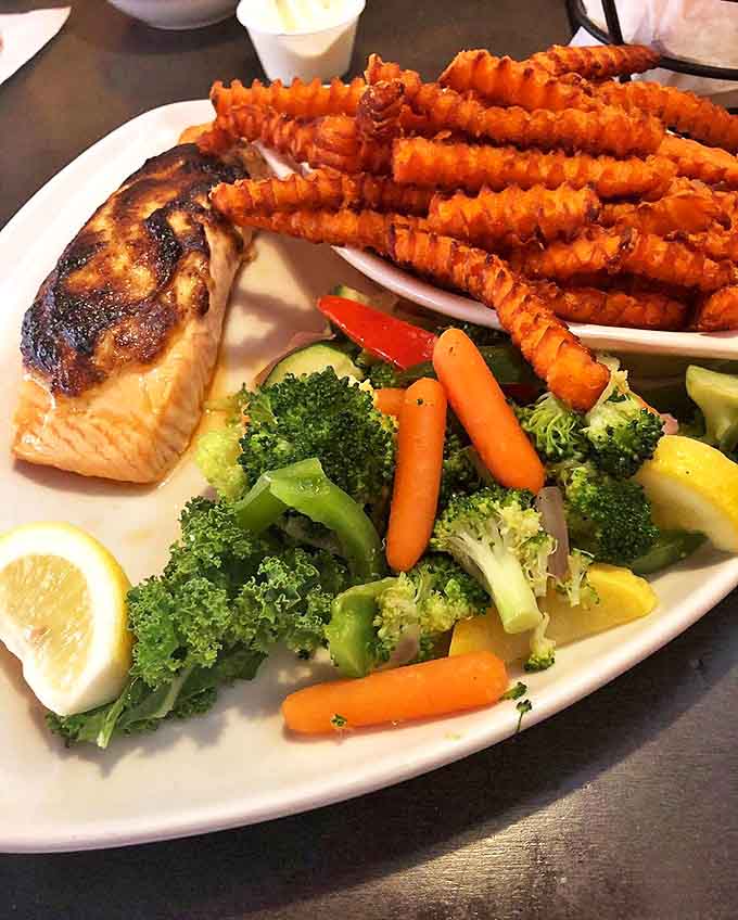 Perfectly grilled salmon with sweet potato fries &ndash; proof that Crazy Horse excels beyond its beefy namesake.