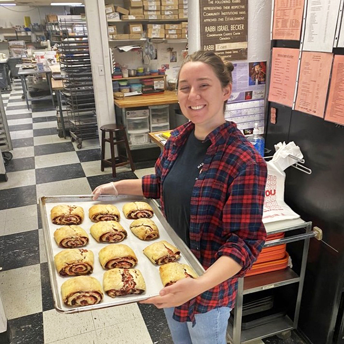Fresh from the oven: a proud baker displays a tray of perfectly rolled rugelach, each one promising a perfect balance of dough and filling.