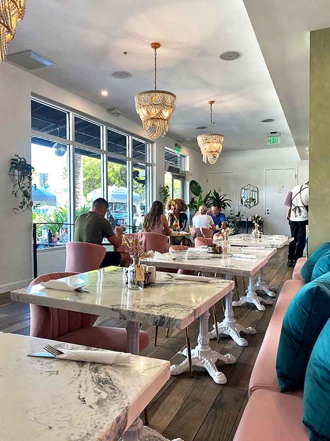 Wooden tables arranged with care create an atmosphere where strangers become neighbors and food becomes the universal language.