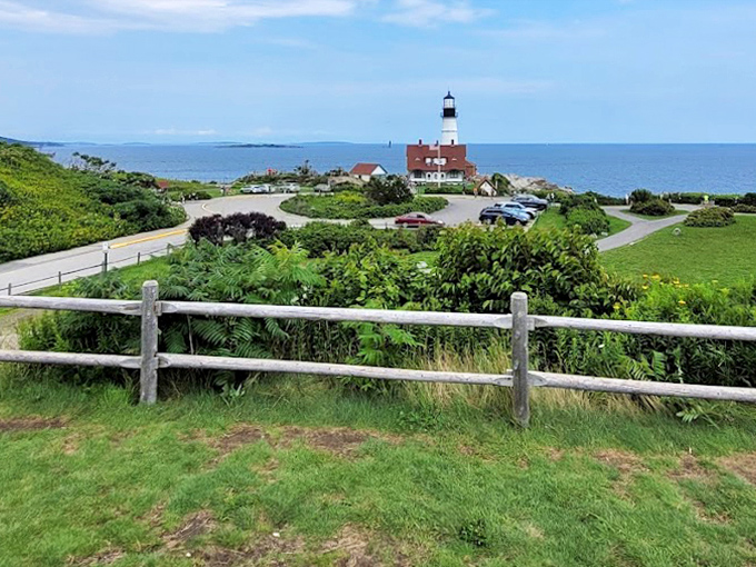 A distant view captures the lighthouse in its natural habitat, standing sentinel where land meets the vast Atlantic Ocean.