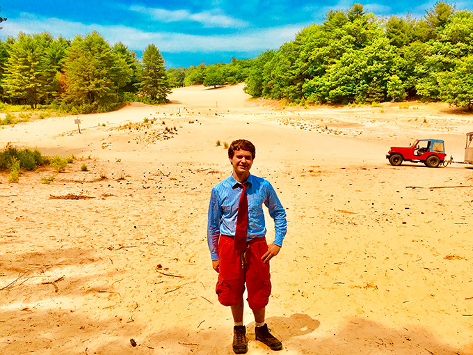A visitor stands amid the expansive sand dunes, looking like he took a wrong turn somewhere between Freeport and the Sahara.