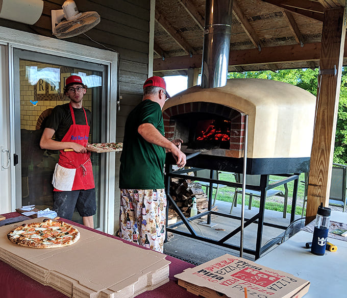 Masters at work: The wood-fired oven transforms simple ingredients into crispy, chewy, slightly smoky perfection in just minutes.