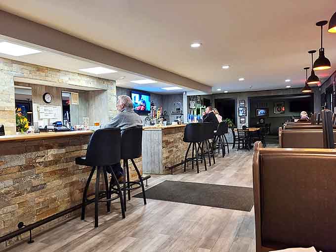 Wood-paneled walls and stone accents create a timeless atmosphere where generations of families have gathered to break bread together.