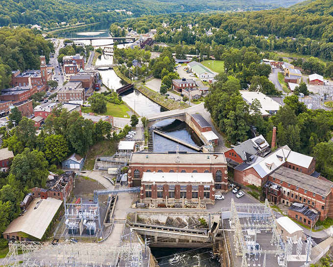 An aerial view highlights how the village developed around the falls and canal system that gave it economic importance.