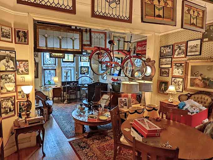 A bicycle hangs suspended among stained glass windows, vintage furniture, and countless memories waiting to be adopted.